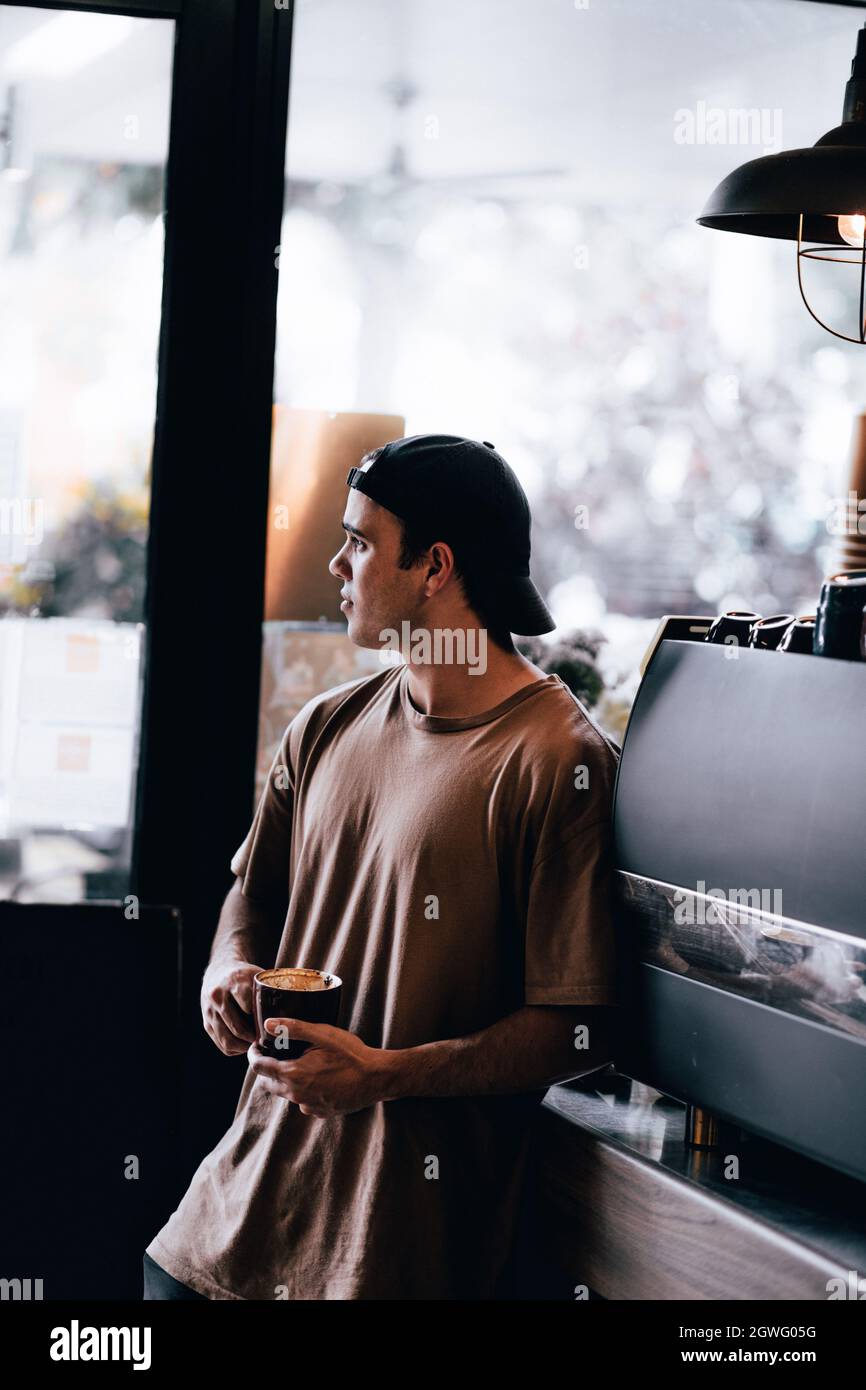 Back of person looking in shop window hi-res stock photography and ...