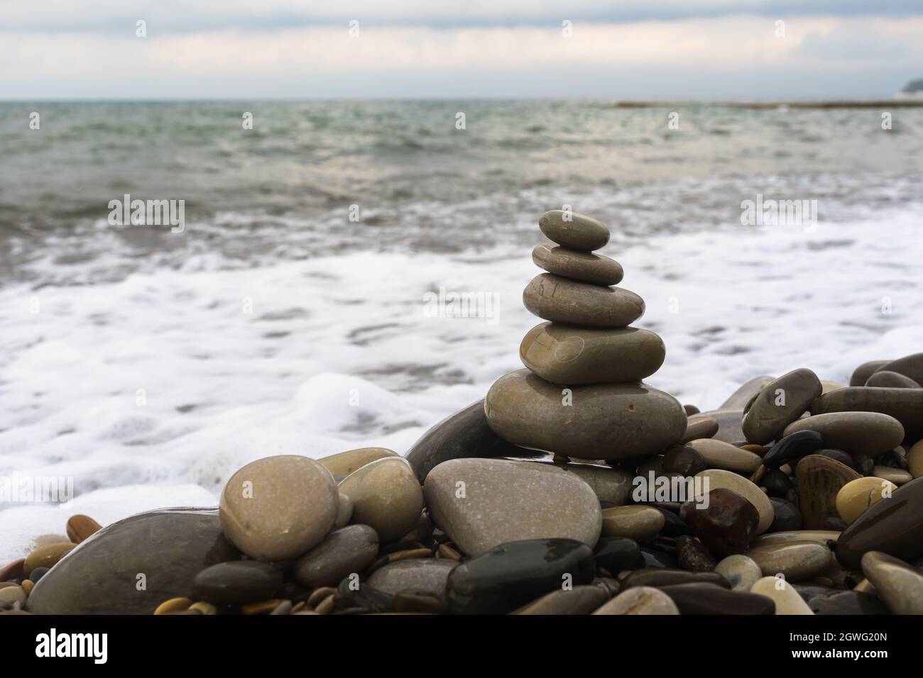 Balancing pyramid of sea stones on a pebble beach Stock Photo - Alamy