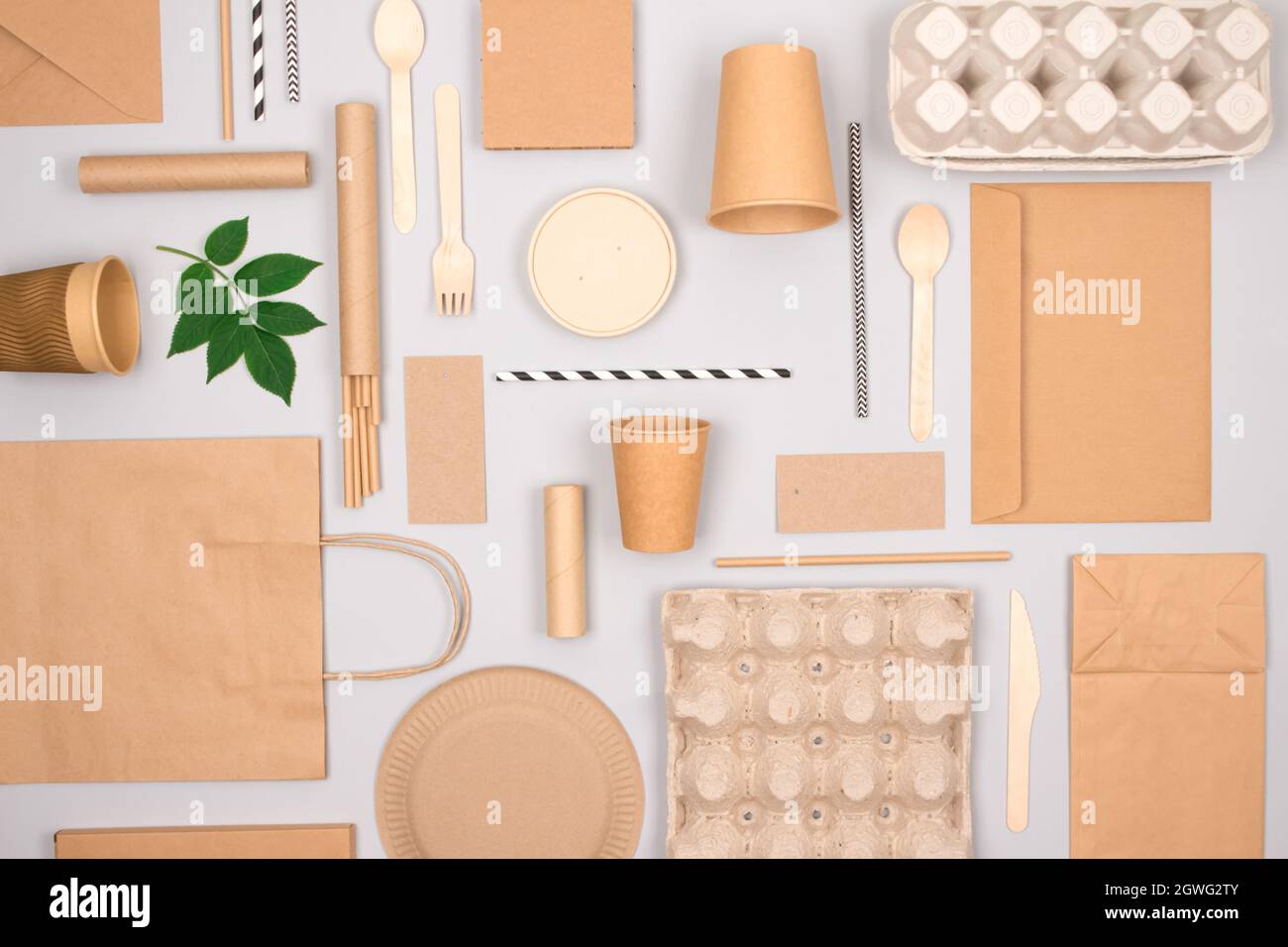 Set of different eco-friendly tableware and kraft paper food packaging ...