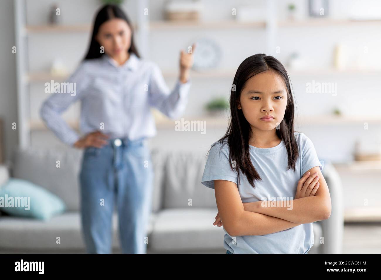 Family conflict. Mother and daughter quarreling at home, sulky child girl ignoring her mom ...
