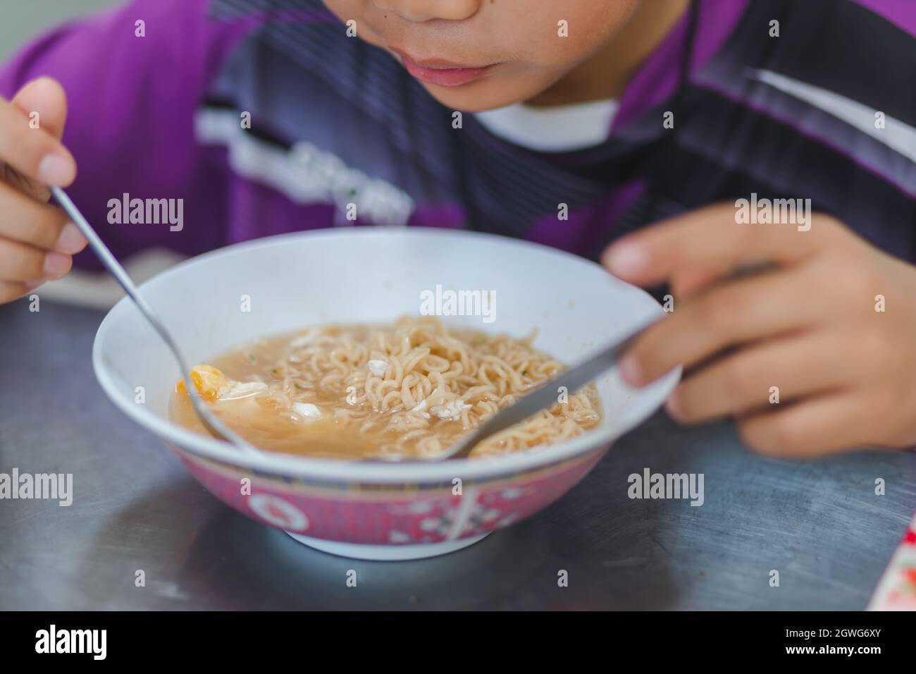 Indian man eating noodles hi-res stock photography and images - Alamy