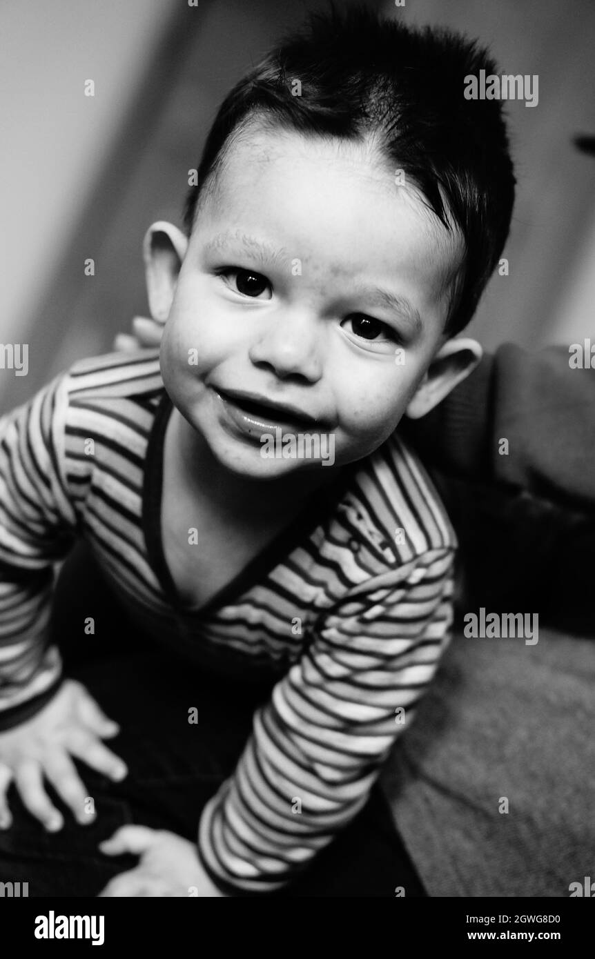 A greyscale portrait of a Caucasian little smiling boy Stock Photo - Alamy