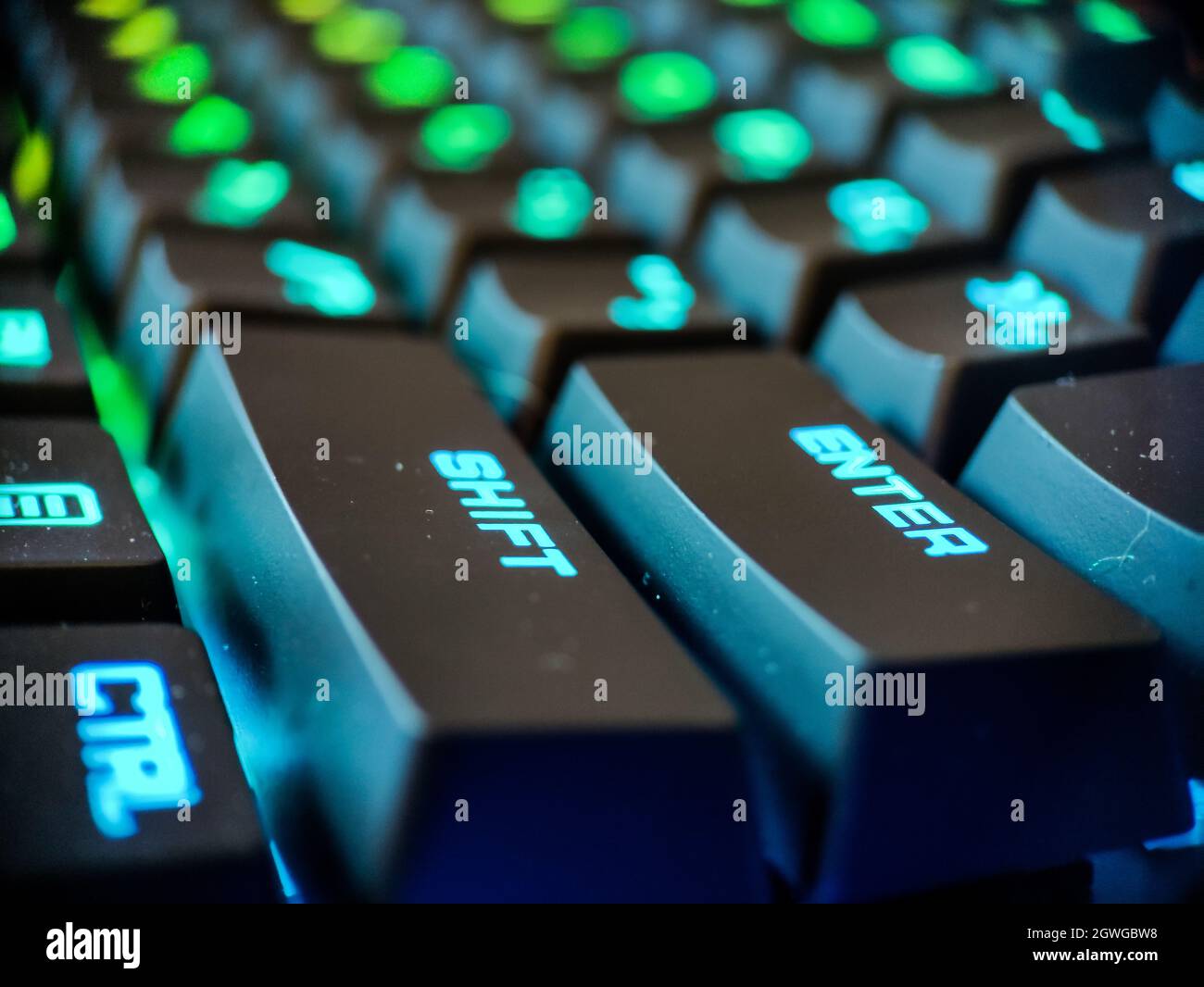 Gamer keyboard with neon backlight macro defocused close up. Online ...