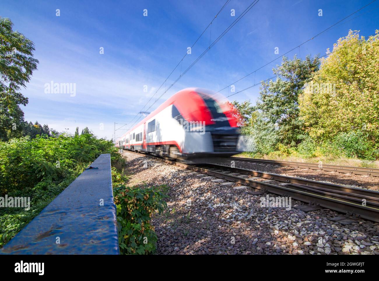 A speeding train on railroad tracks, image blurred by speed. Vivid ...