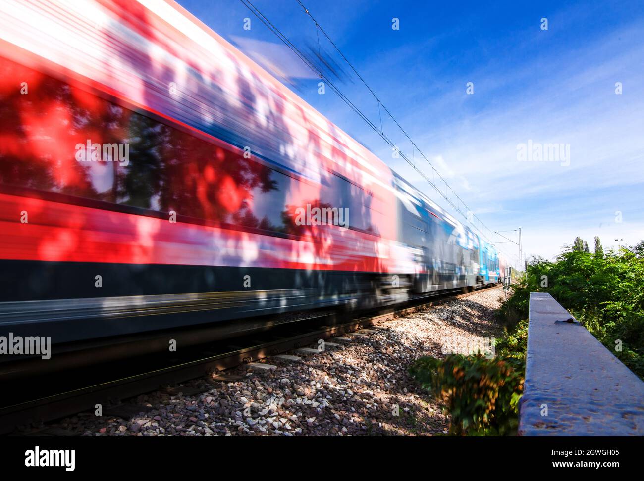 A speeding train on railroad tracks, image blurred by speed. Vivid ...