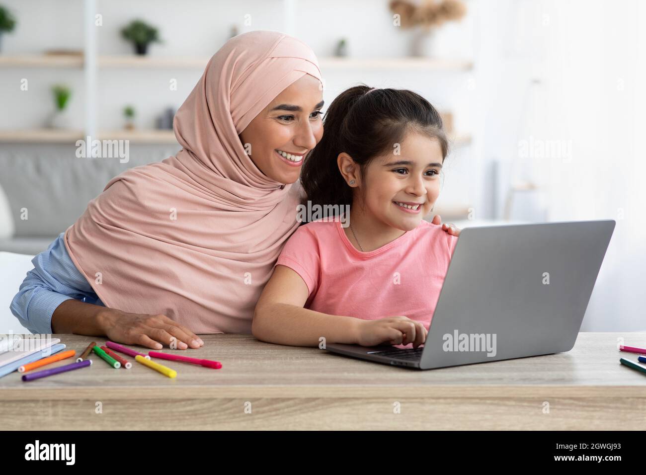 Online Education. Muslim Mom In Hijab And Her Little Daughter Using ...