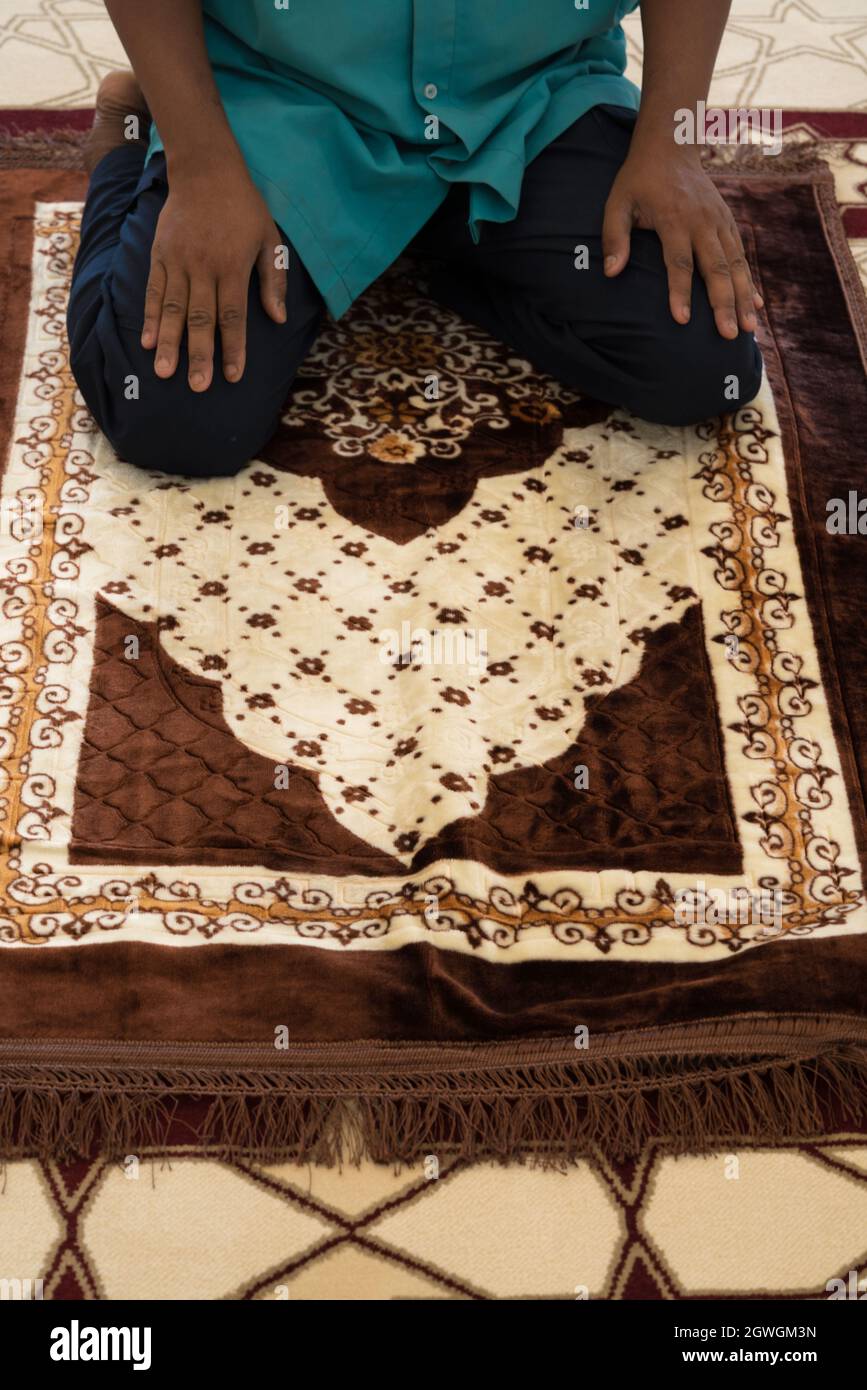 Young men praying at mosque hi-res stock photography and images - Alamy