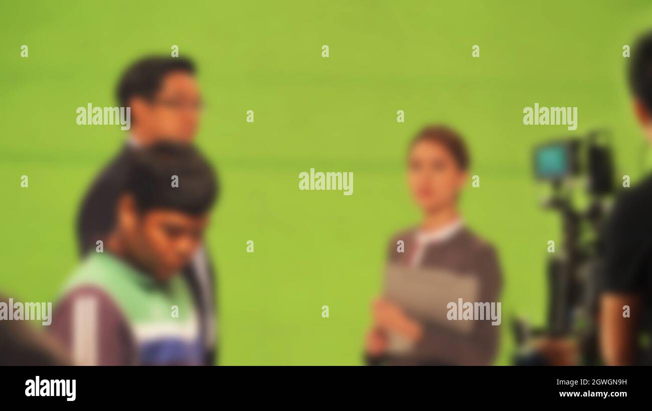 Blurry images of making TV commercial movie video in big green screen ...