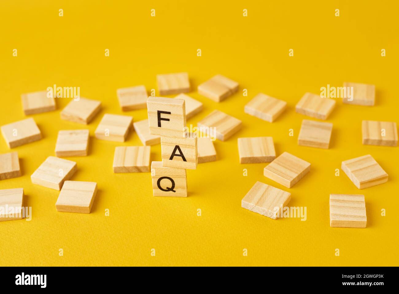 Wooden Blocks With Word Faq On Yellow Baclground. Frequently Asked ...