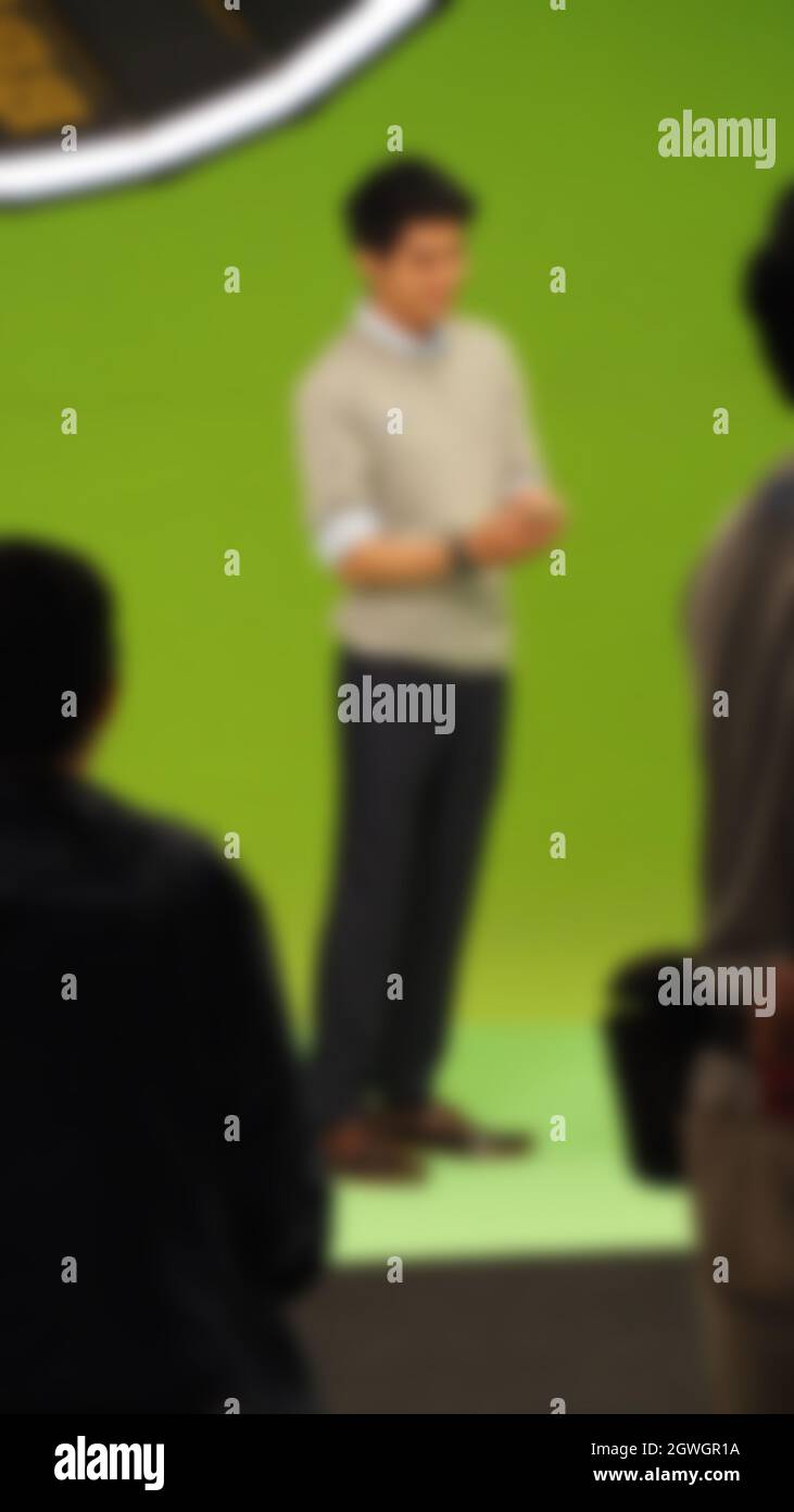 Blurry images of making TV commercial movie video in big green screen ...