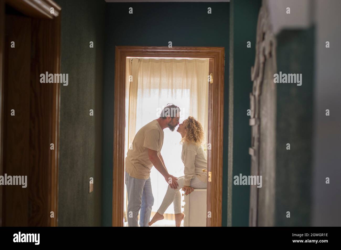 Loving couple kissing each other at home. Profile of affectionate ...