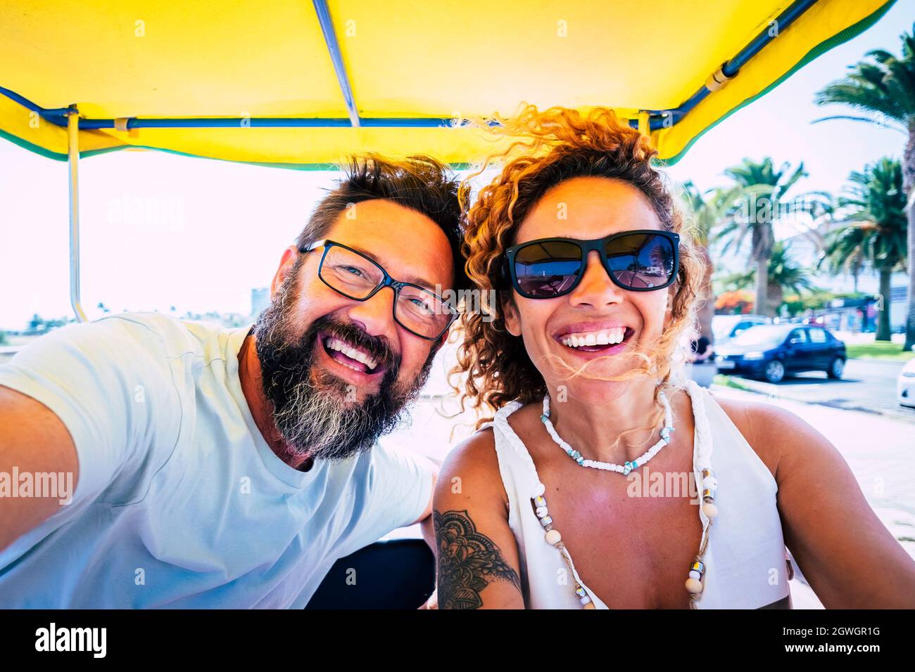 Portrait of cheerful caucasian couple enjoying vacation during road ...