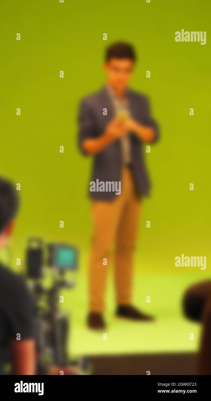 Blurry images of making TV commercial movie video in big green screen ...