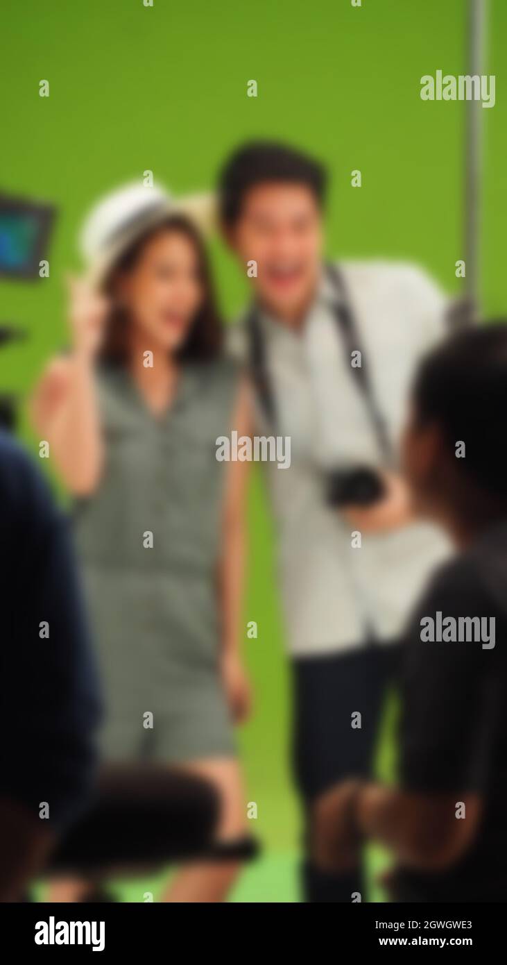 Blurry images of making TV commercial movie video in big green screen ...