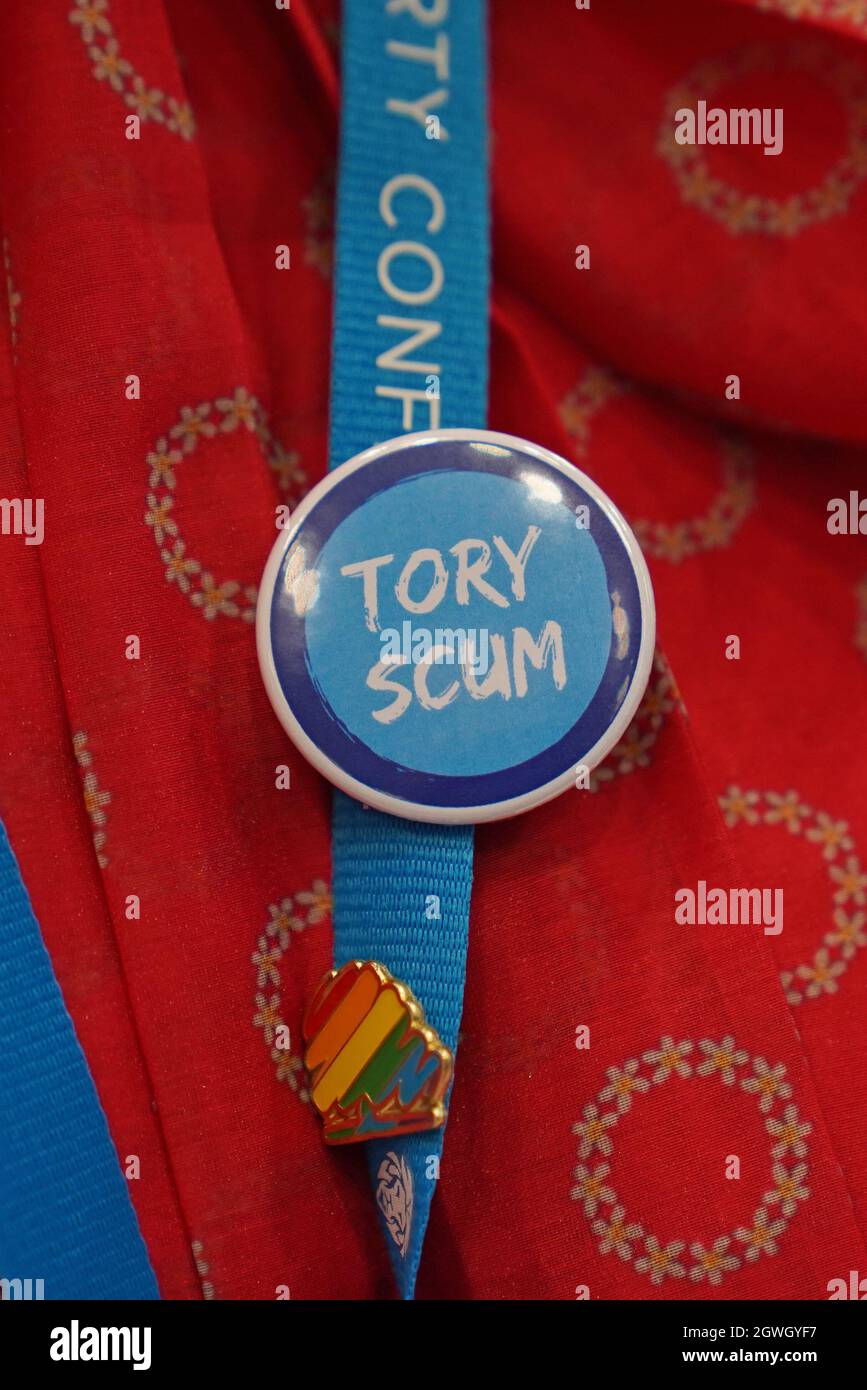 A delegate wears a badge at the Conservative Party Conference in ...