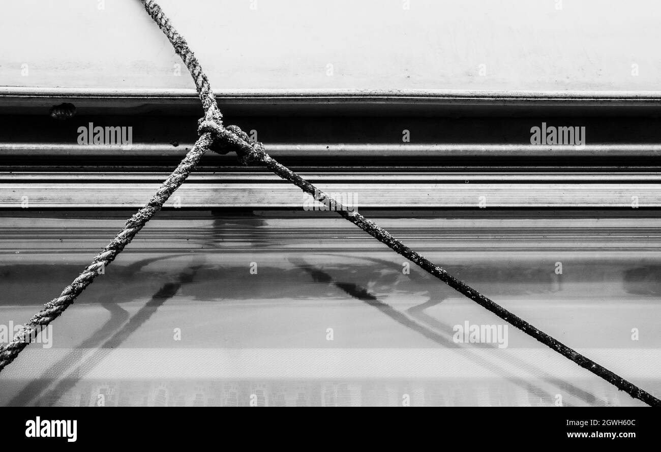 A monochrome shot of two tied up dirty ropes Stock Photo - Alamy