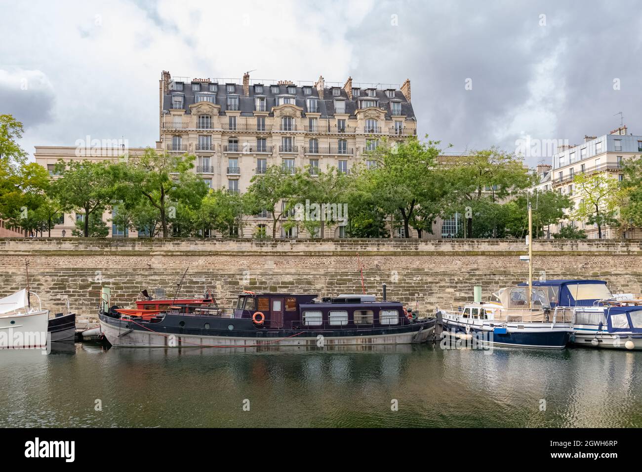 Paris, Bastille, beautiful harbor with houseboats, and typical facade ...
