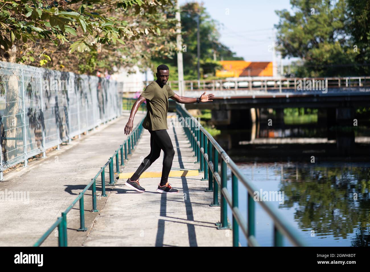Young man running by canal hi-res stock photography and images - Alamy