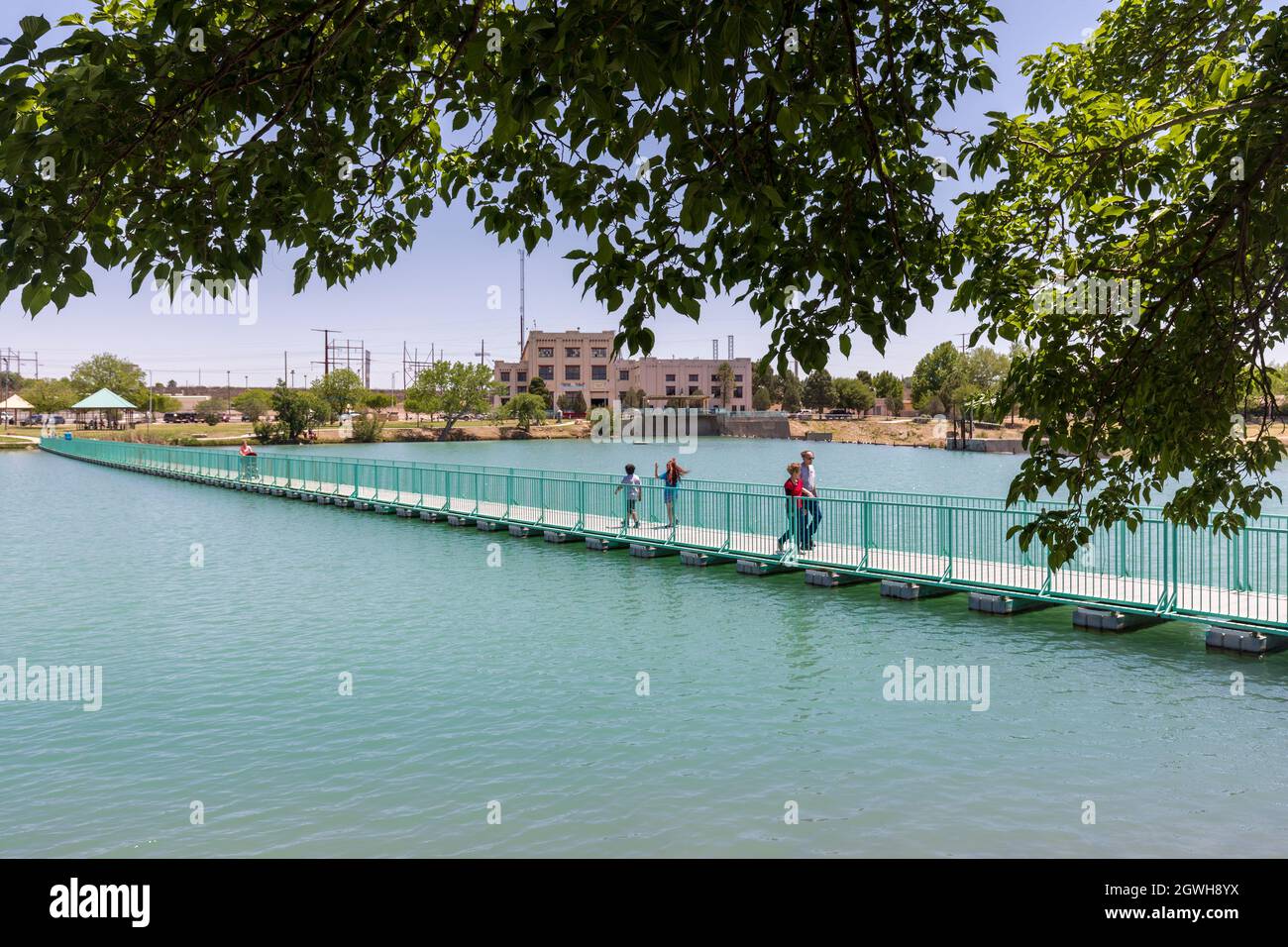 People crossing the Pecos River on a floating footbridge, Carlsbad, New ...