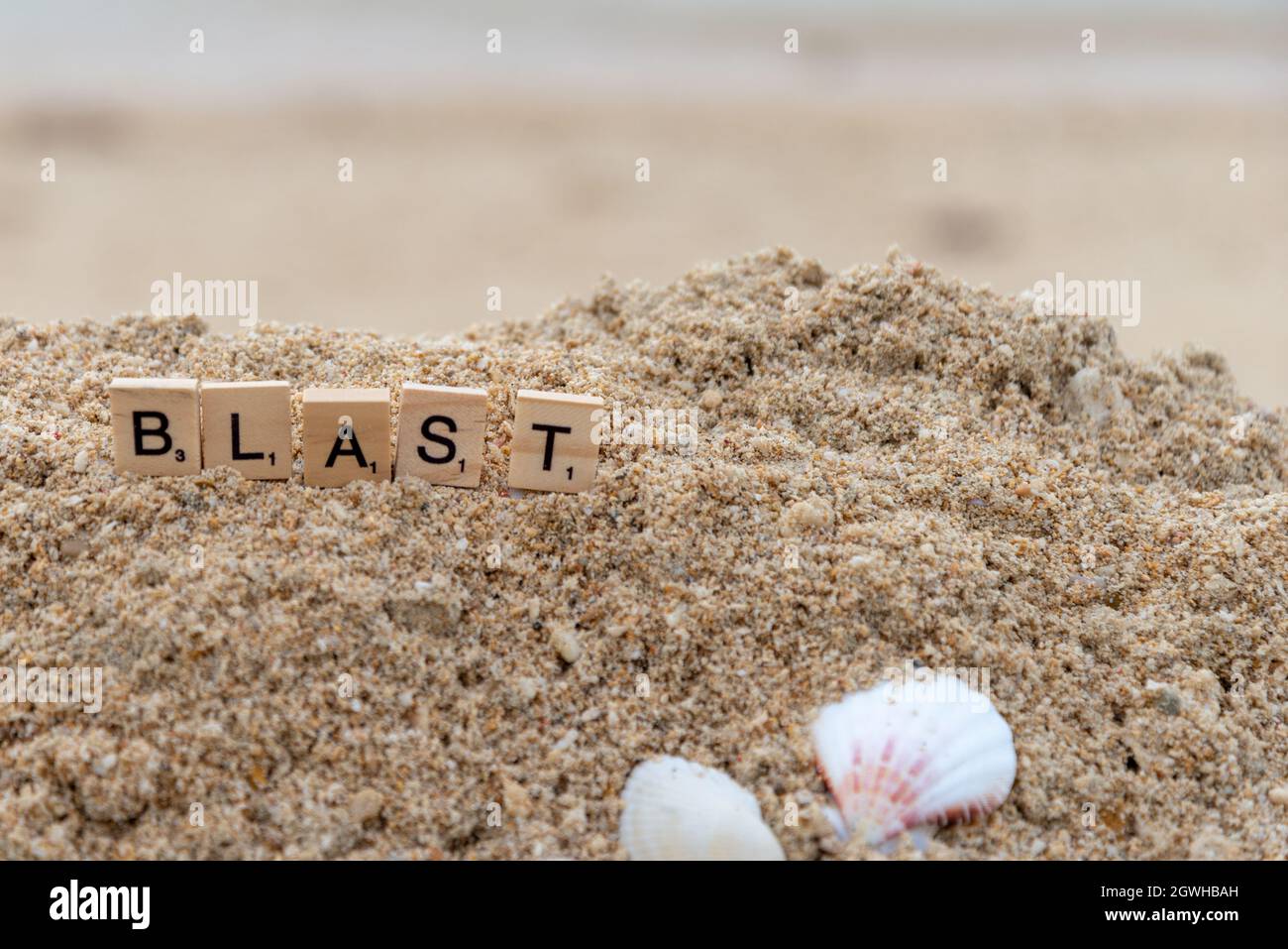 scrabble word written on the sand, blast Stock Photo - Alamy