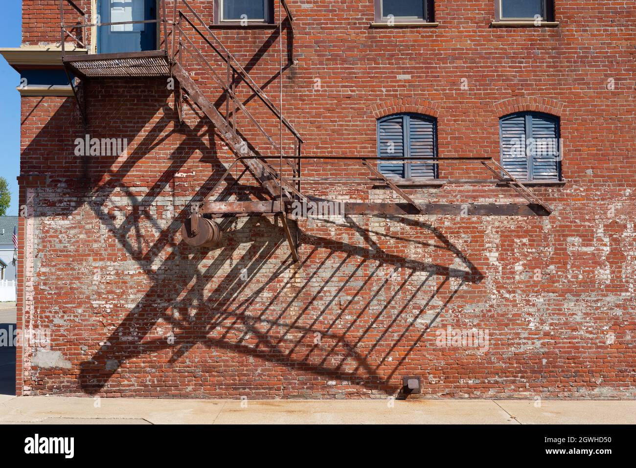 Exterior of old brick building with rusted fire escape Stock Photo - Alamy