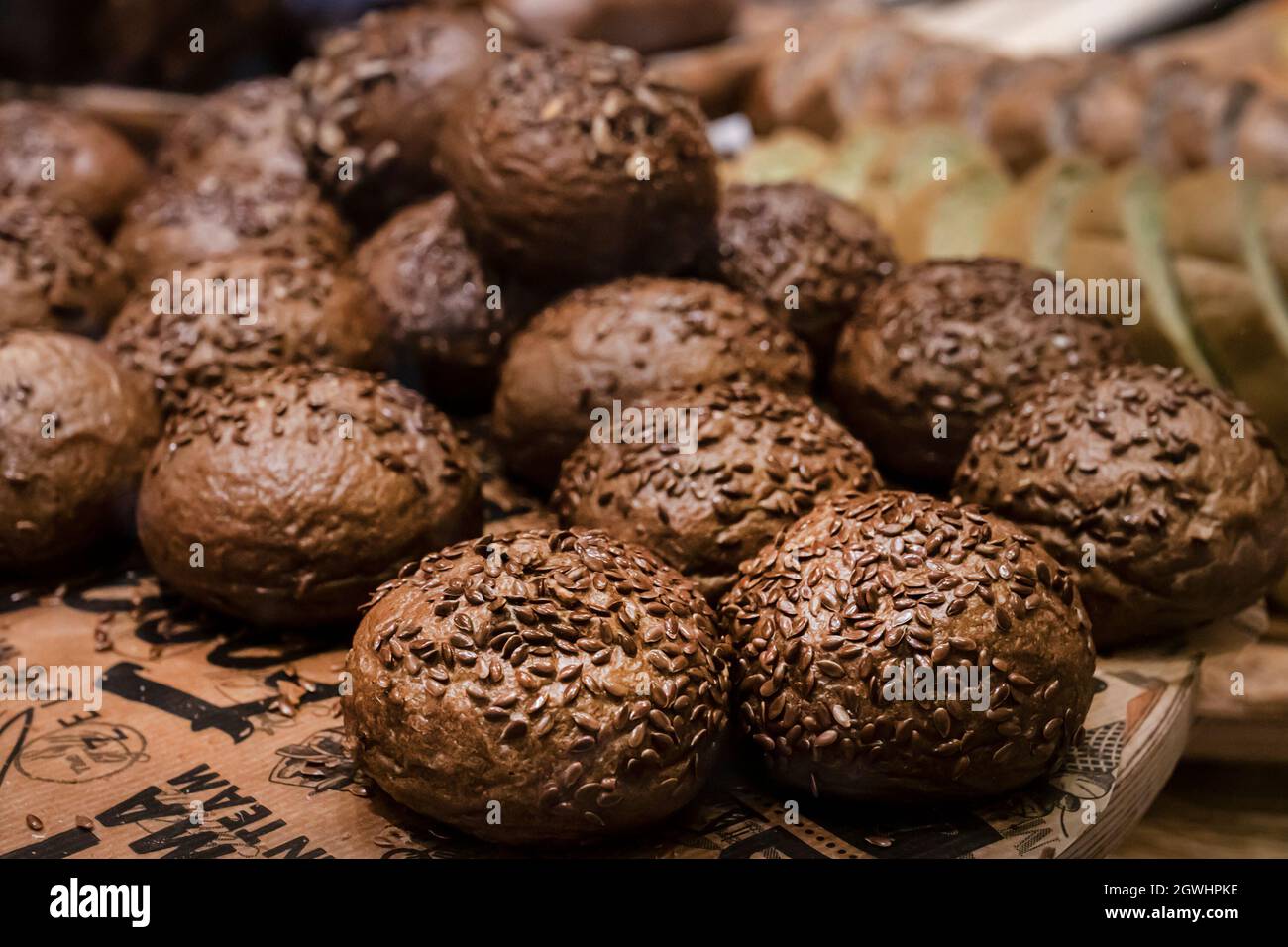 black round buns, sprinkled with grain. fresh pastries, brown little ...