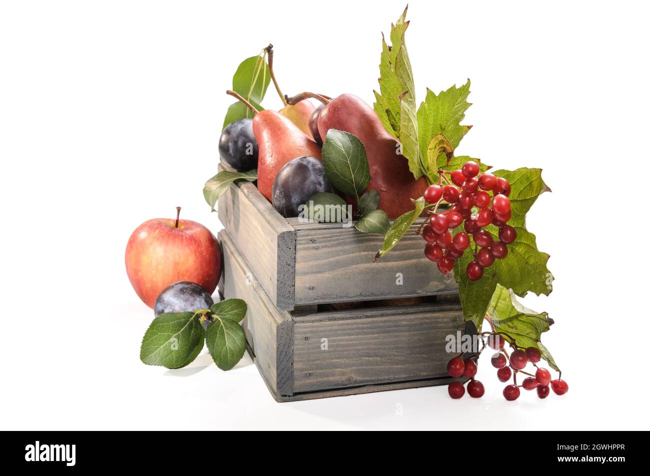 fruits and berries in a wooden box on a white background with soft ...