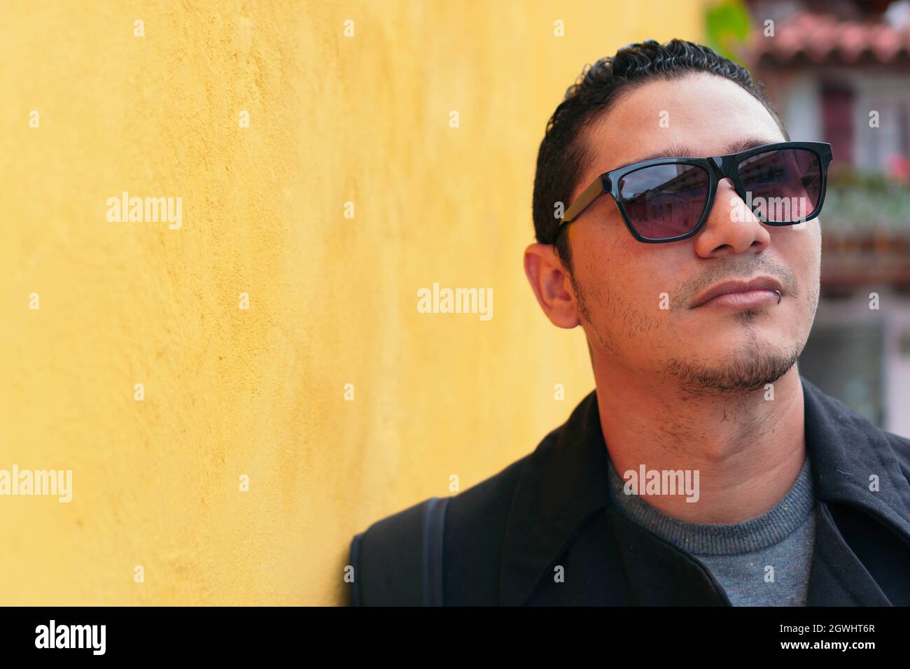 Portrait of handsome hipster Latin man looking away. Lifestyle concept ...