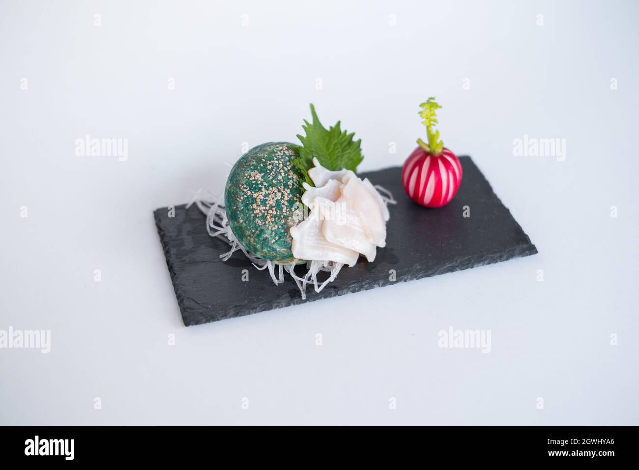 Decorated sashimi on black tray in Japanese restaurant. Perfectly ...