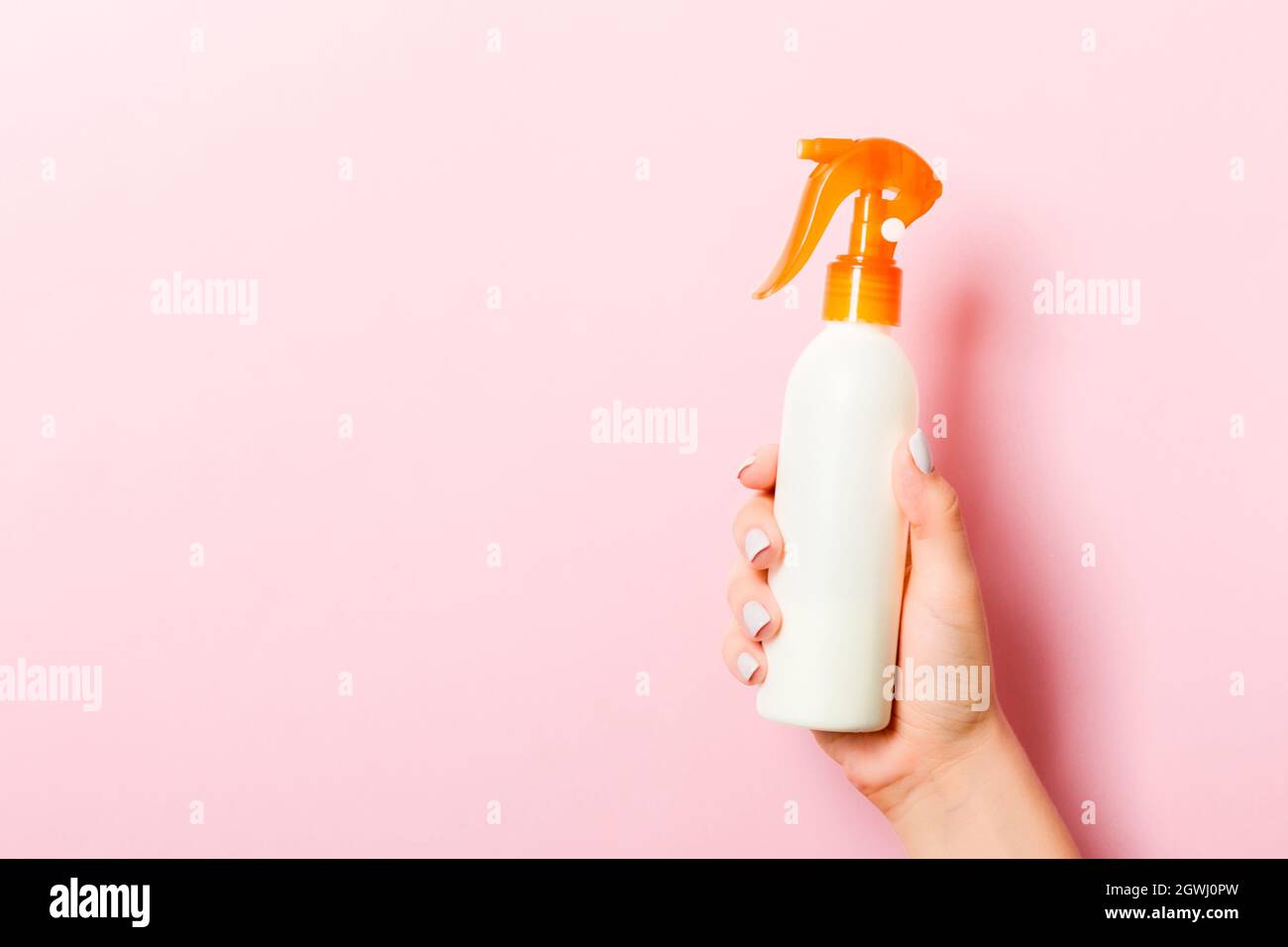 Close Up Of Woman's Hand Holding A Spray Of Cosmetics Product At Pink ...
