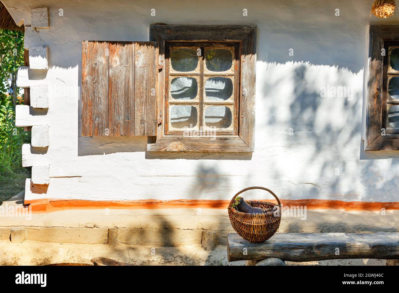 An old window with wooden shutters of a Ukrainian rural hut under a ...