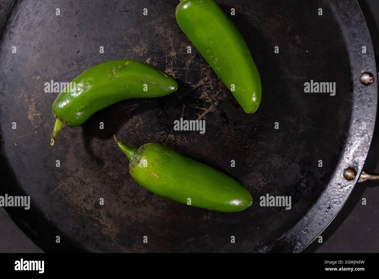 Green chili peppers on a traditional Mexican comal Stock Photo - Alamy