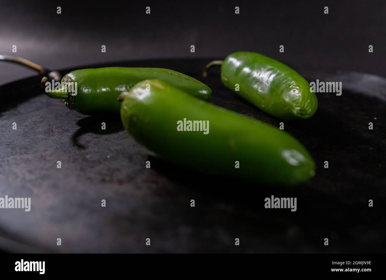 Green chili peppers on a traditional Mexican comal Stock Photo - Alamy