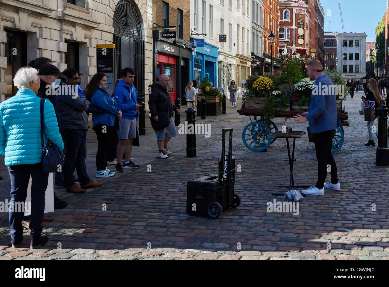 Magician busker entertaing the crowd in Covent Garden UK Stock Photo ...