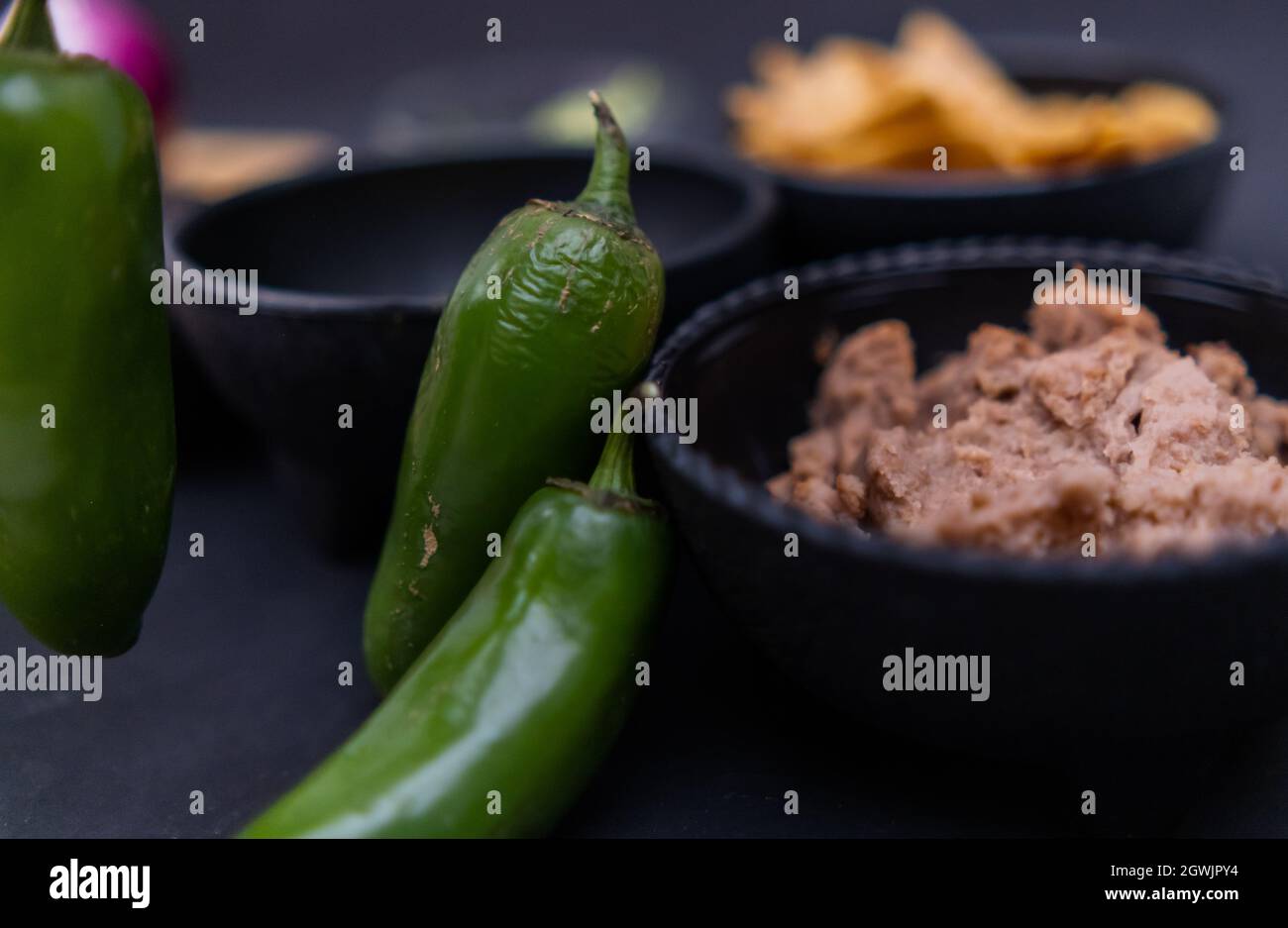 Chili peppers leaning against bowls hi-res stock photography and images ...