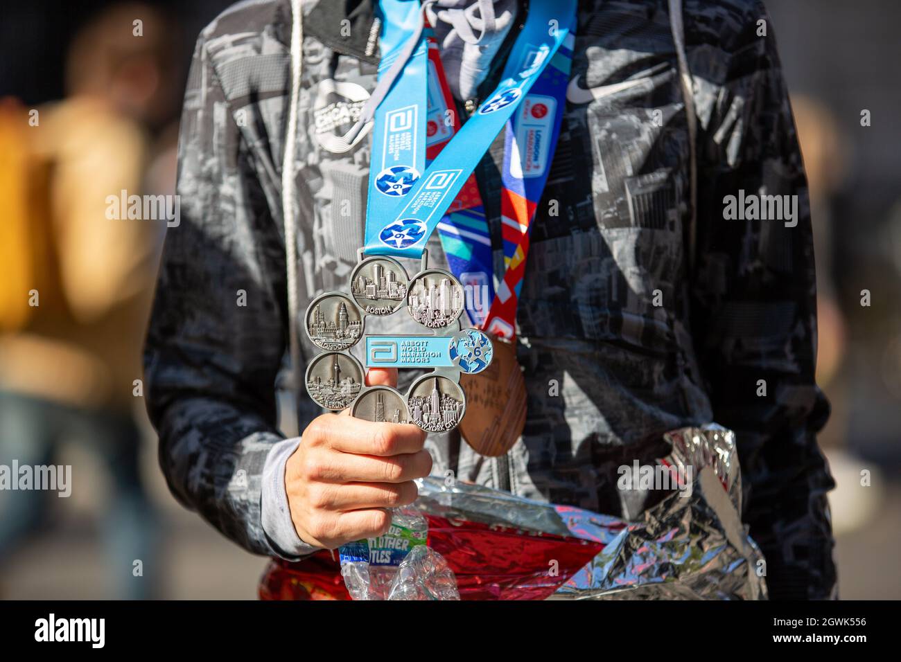 A runner holds a medal after taking part in the 41st 2021 London ...