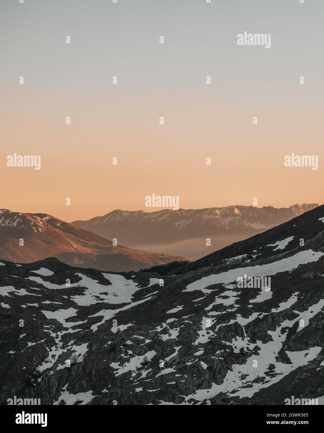 A vertical shot of a beautiful mountainous area covered with snow ...