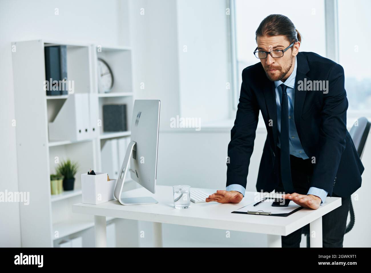 The man in a suit in the office gestures with his hands boss Stock ...