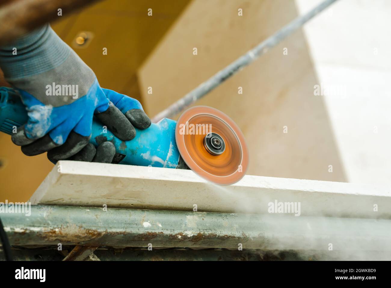 A close-up shot of a hand holding masonry machine to polish marble ...