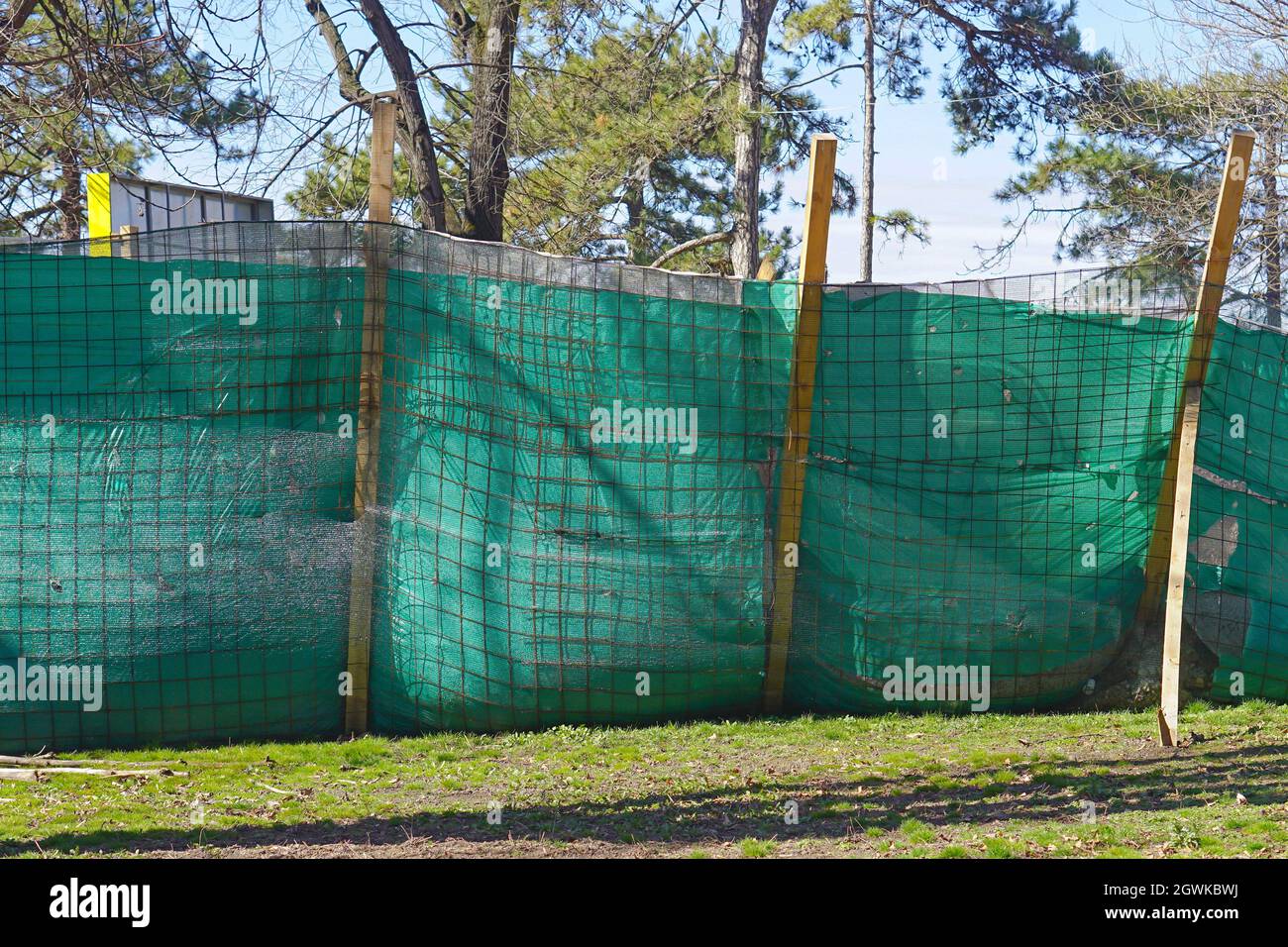 Green fence at construction site in park Stock Photo - Alamy