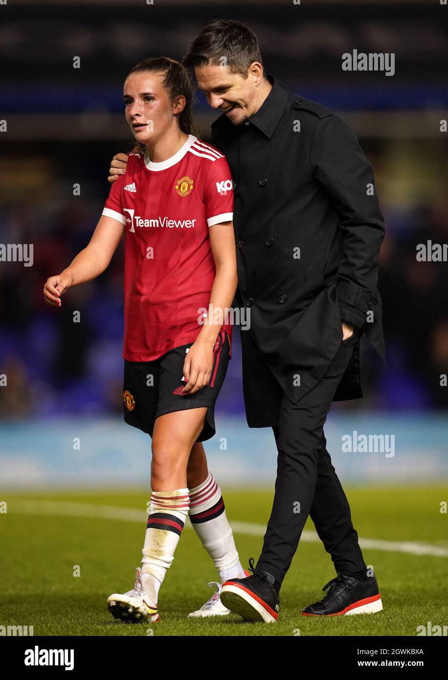 Manchester United head coach Marc Skinner (right) speaks to Manchester ...