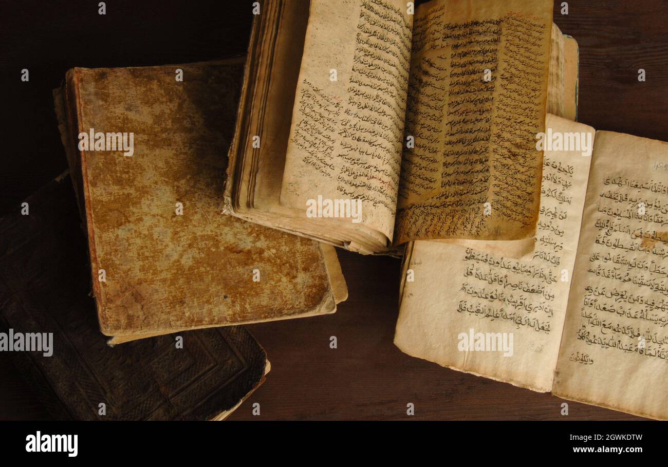 Stack of open ancient books in Arabic. Old Arabic manuscripts and texts ...