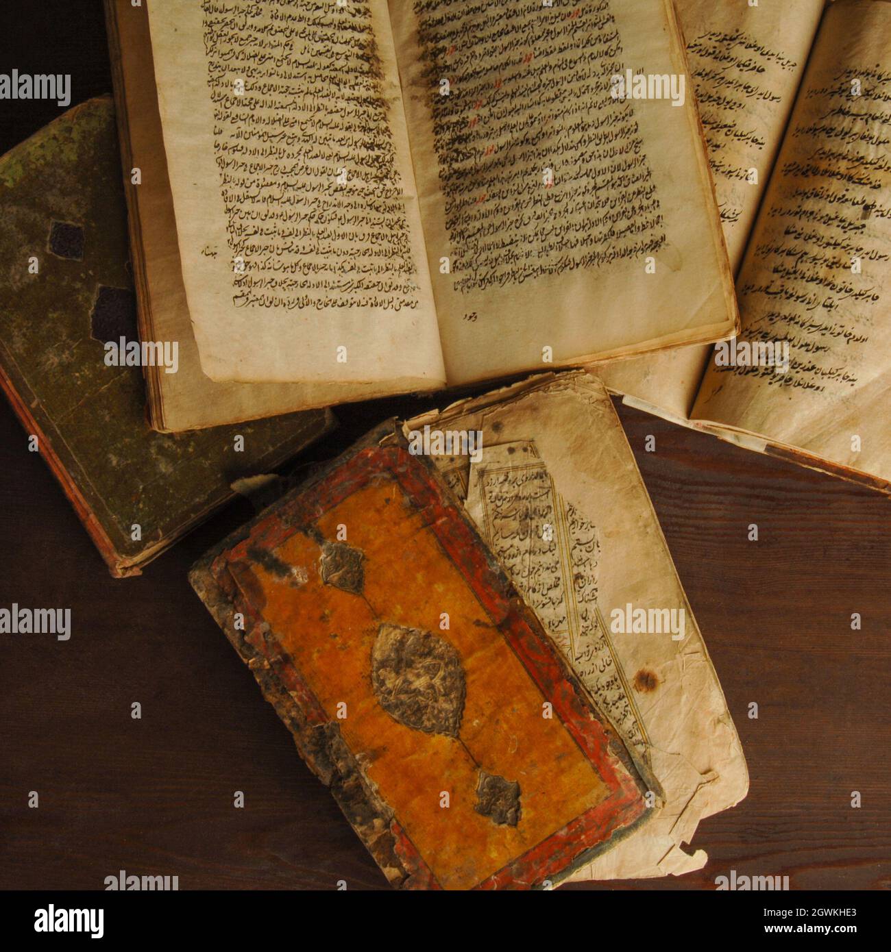 Stack of open ancient books in Arabic. Old Arabic manuscripts and texts ...