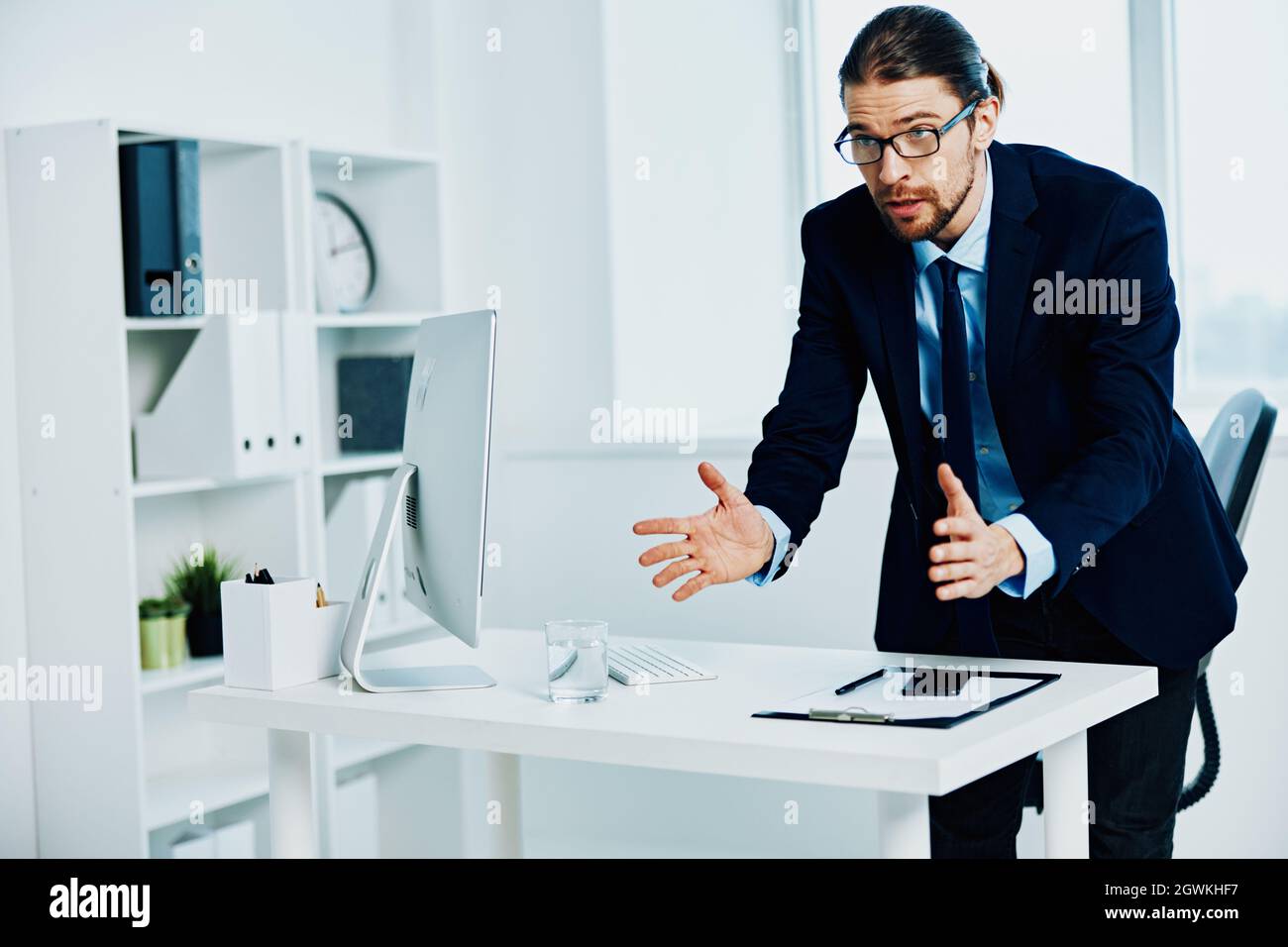 The man in a suit in the office gestures with his hands boss Stock ...