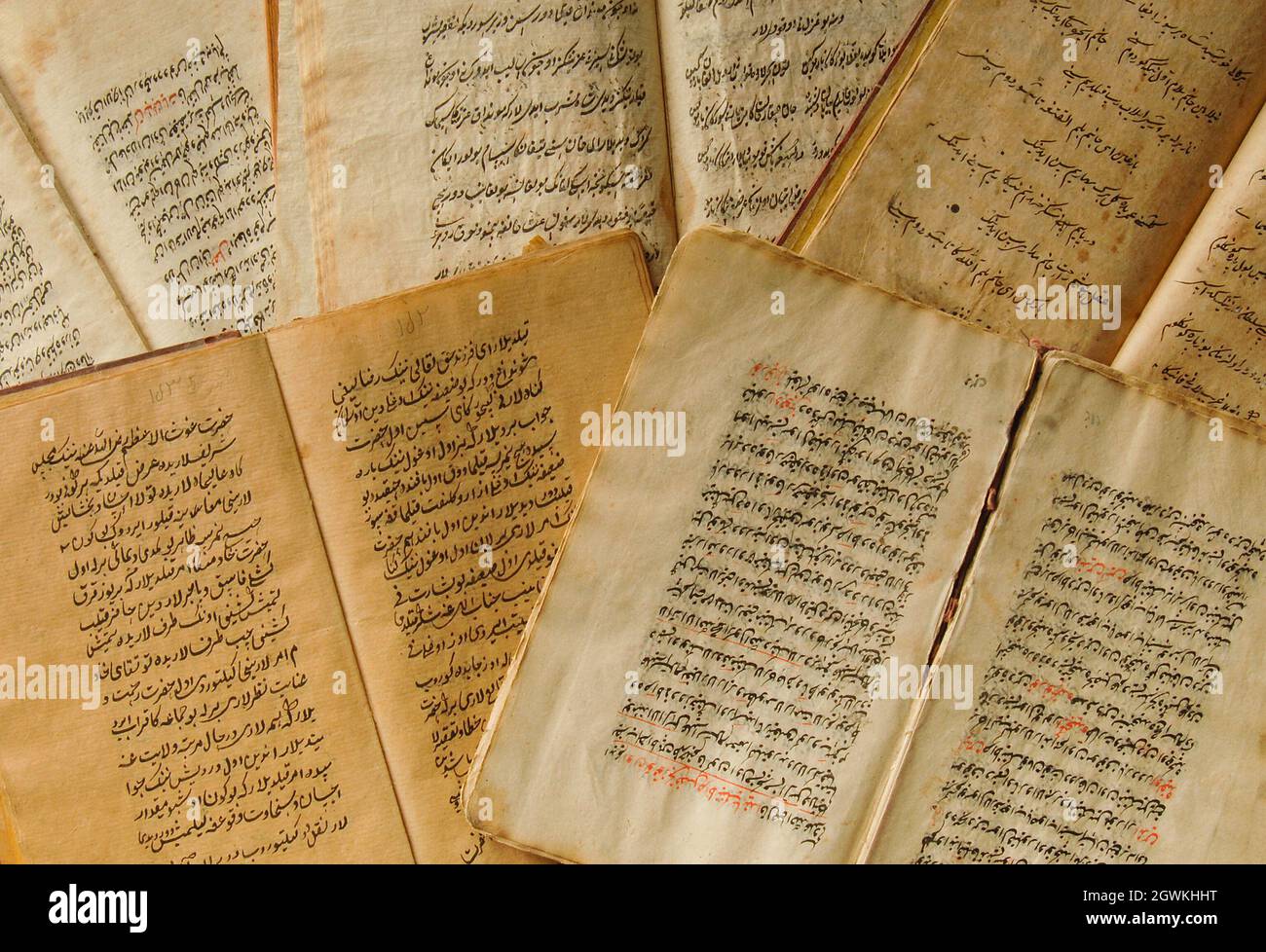 Stack of open ancient books in Arabic. Old Arabic manuscripts and texts ...