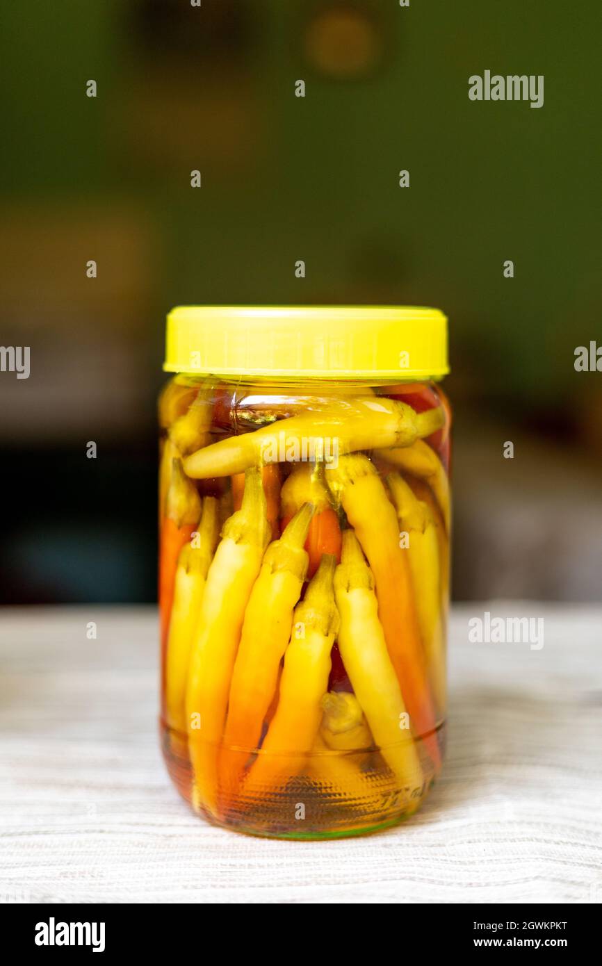 Fermented chili peppers in a glass jar. Winter preserved food Stock ...