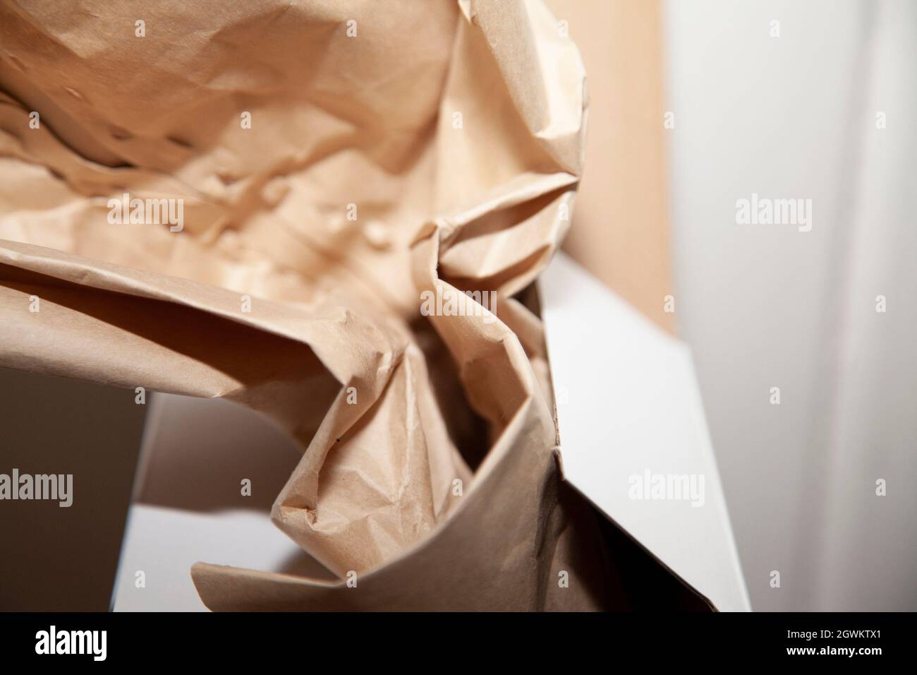 Brown packing paper sticking out of a box Stock Photo - Alamy