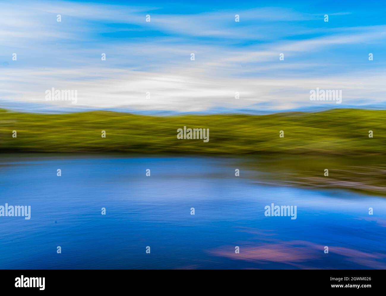 Abstract background created by camera motion of a river bank with the ...