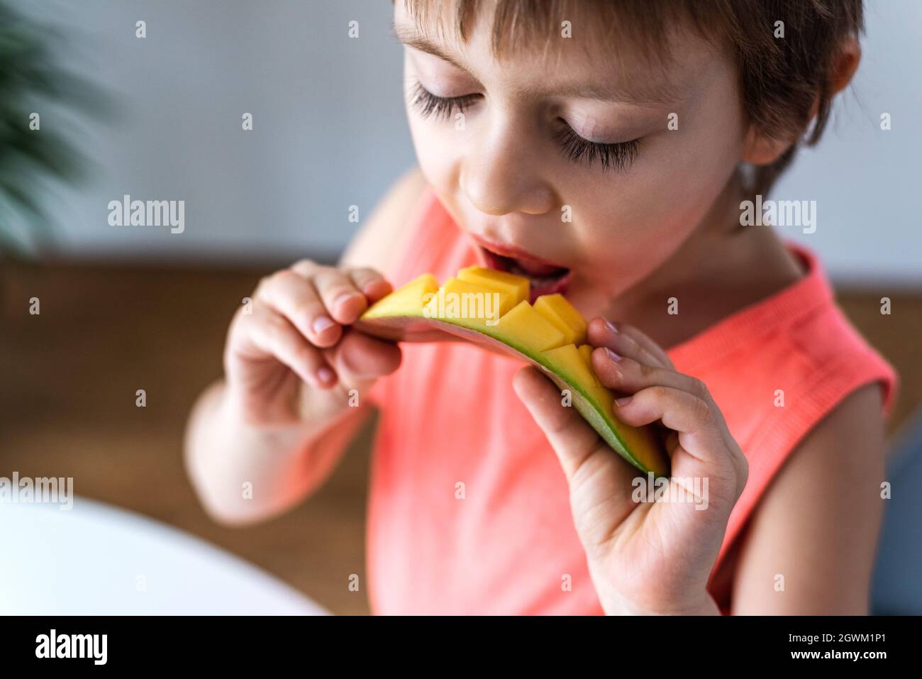 Boy eating mango hi-res stock photography and images - Alamy