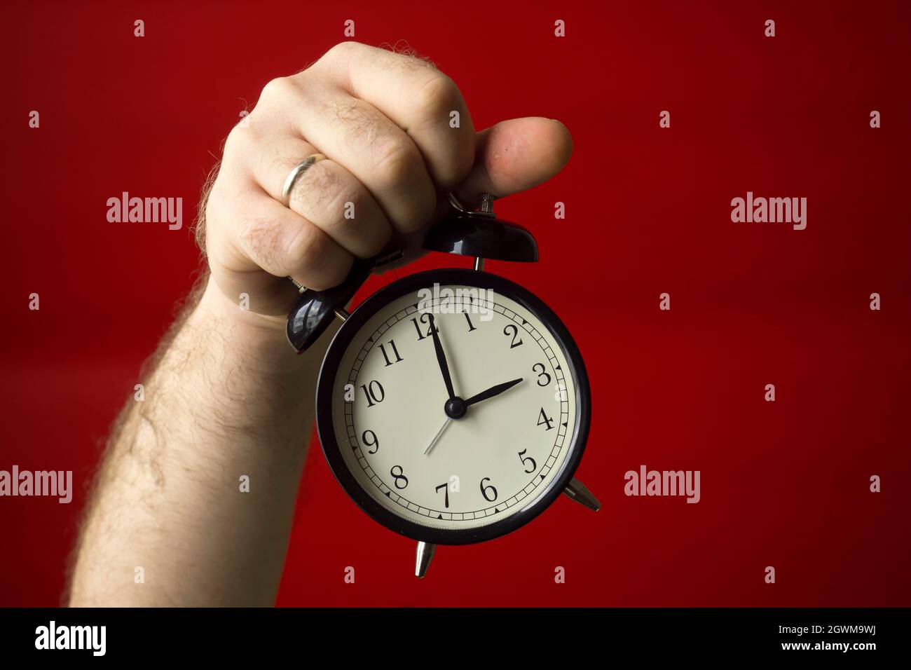 Alarm Clock In A Man's Hand Stock Photo - Alamy